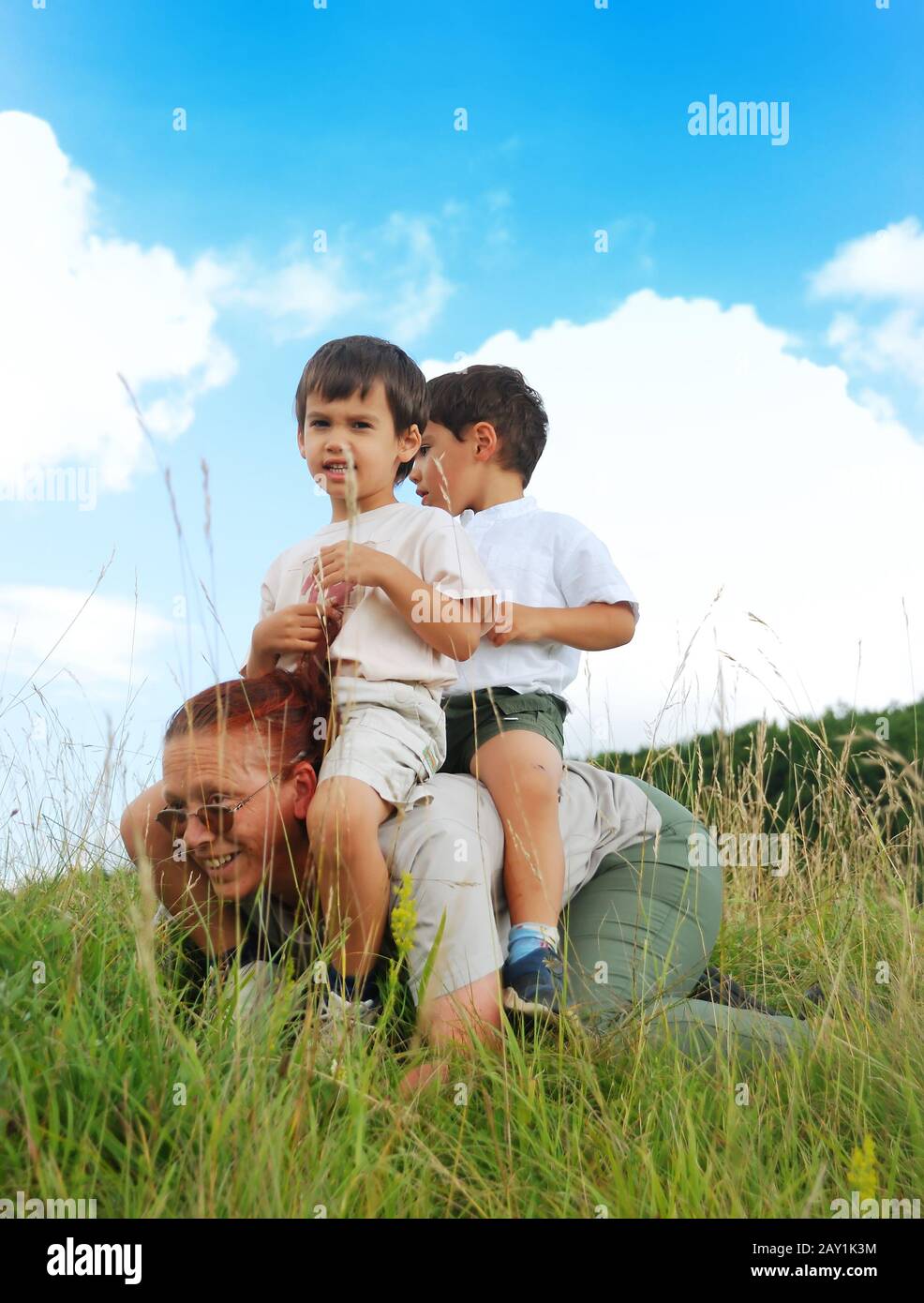 Two kids on back of their gradmother Stock Photo - Alamy