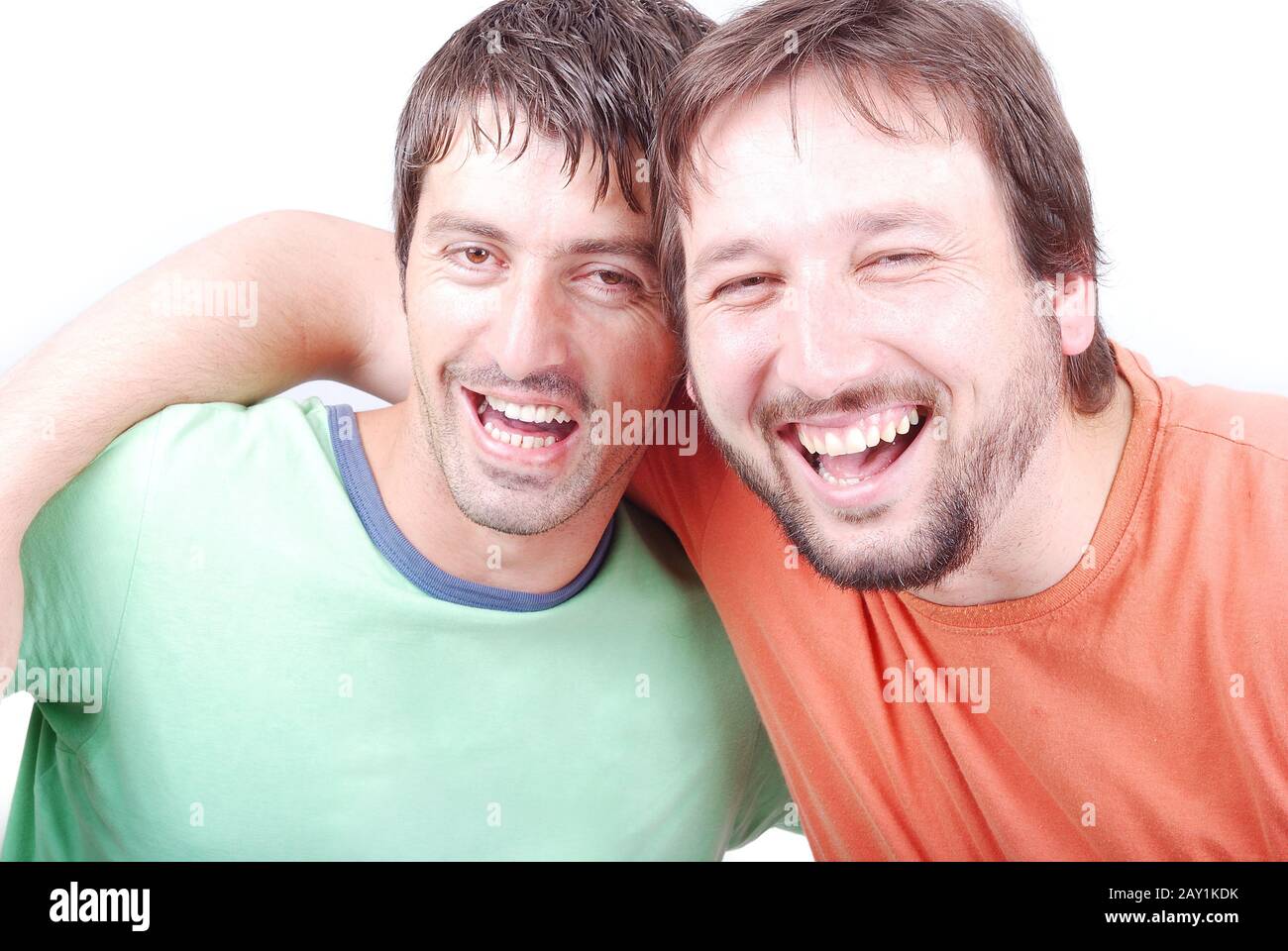 Two funny men are laughing wideli and huging each other Stock Photo - Alamy