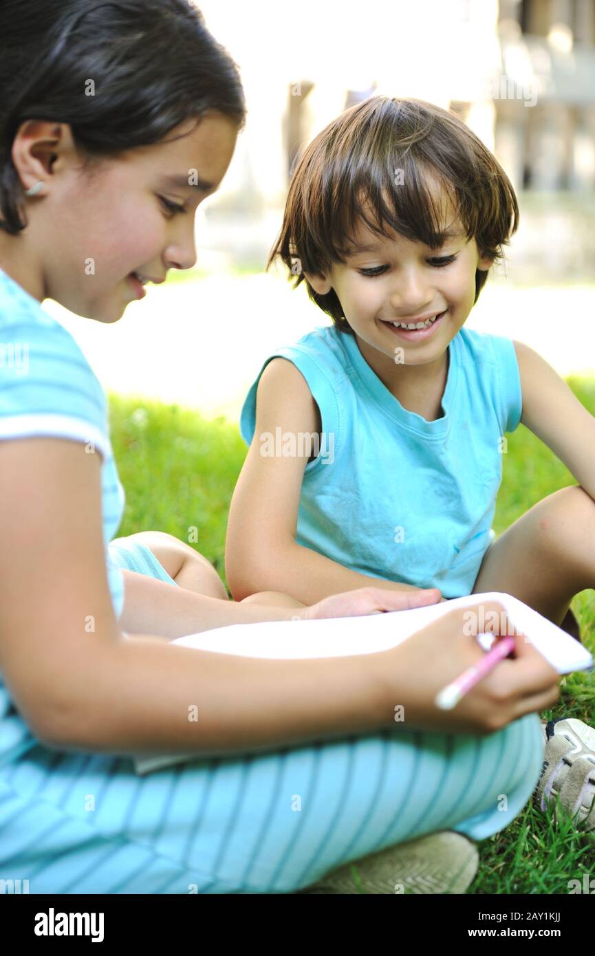 Two kids writing hi-res stock photography and images - Alamy