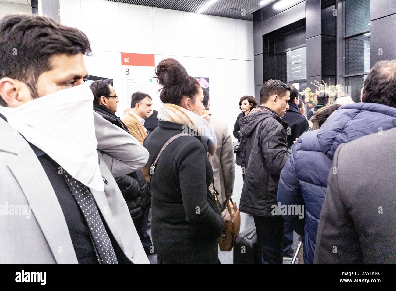 Crowd of people queuing for exit from an international fair during the ...