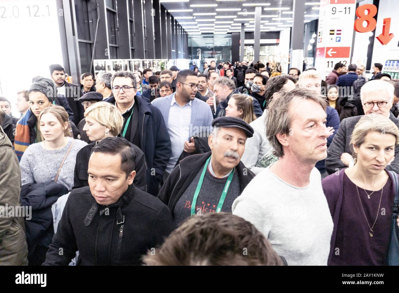 Crowd of people queuing for exit from an international fair during the ...