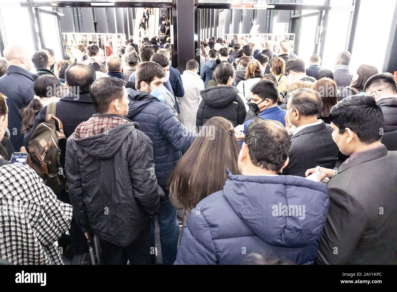 Crowd of people queuing for exit from an international fair during the ...