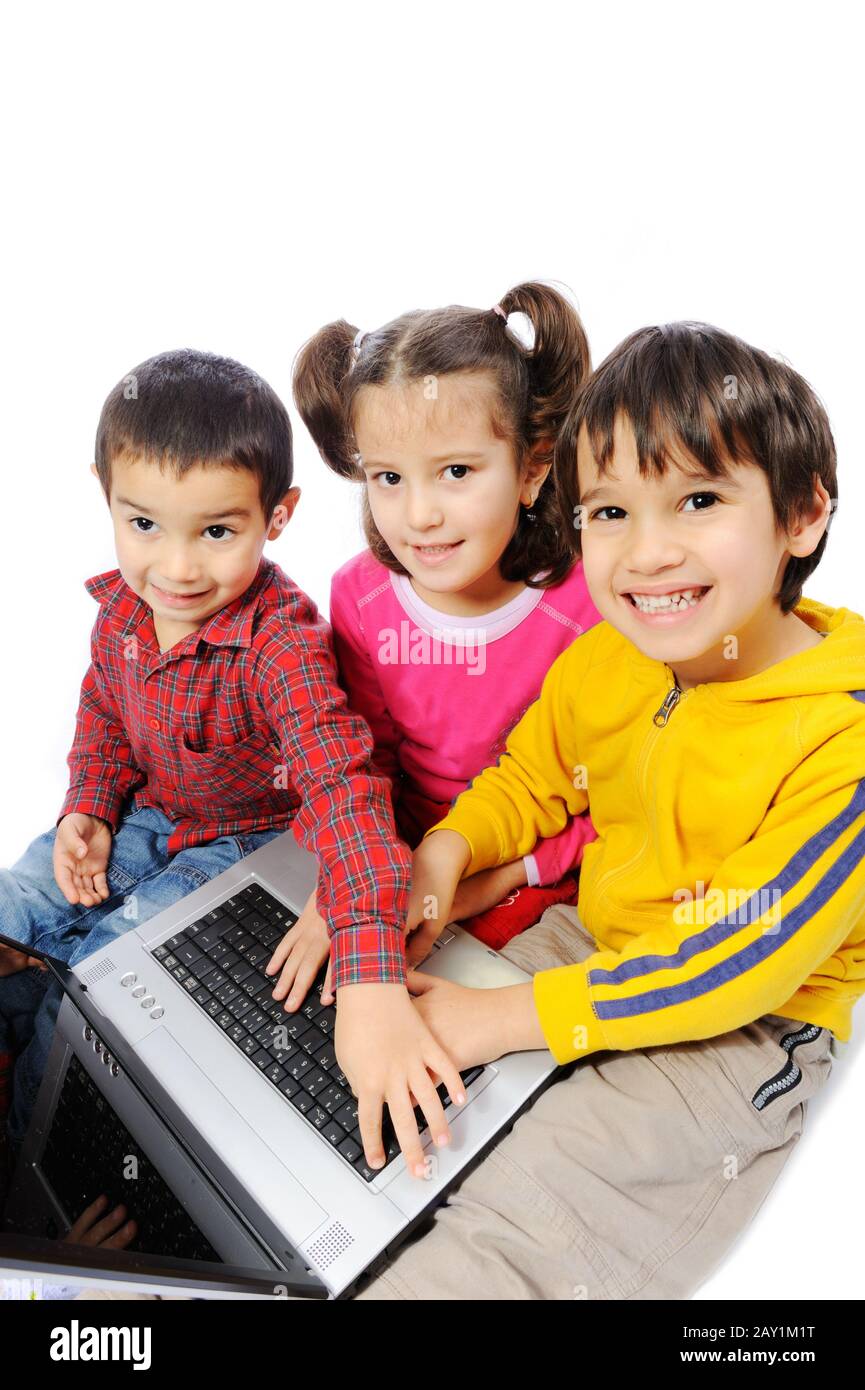 Beautiful smiling kids playing with laptop Stock Photo - Alamy