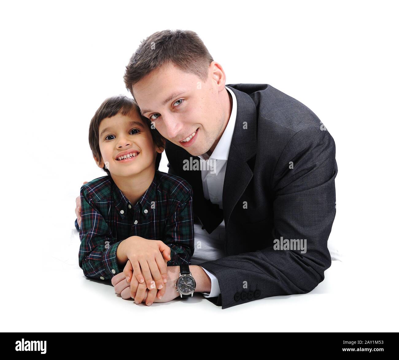 Happy father and son lying on ground together Stock Photo - Alamy