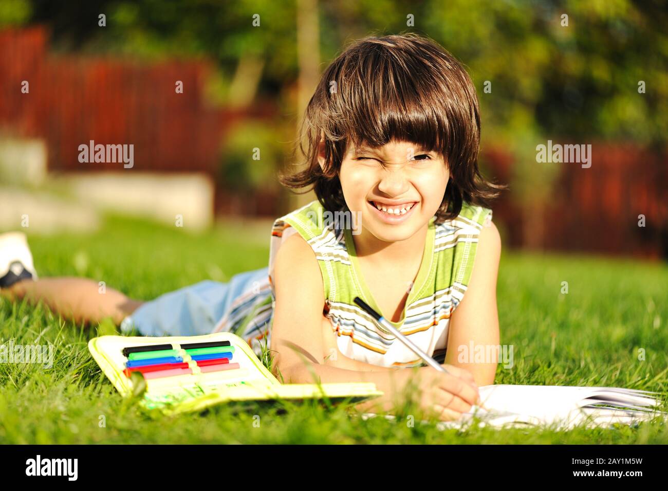 Boy doing home work outdoors Stock Photo - Alamy