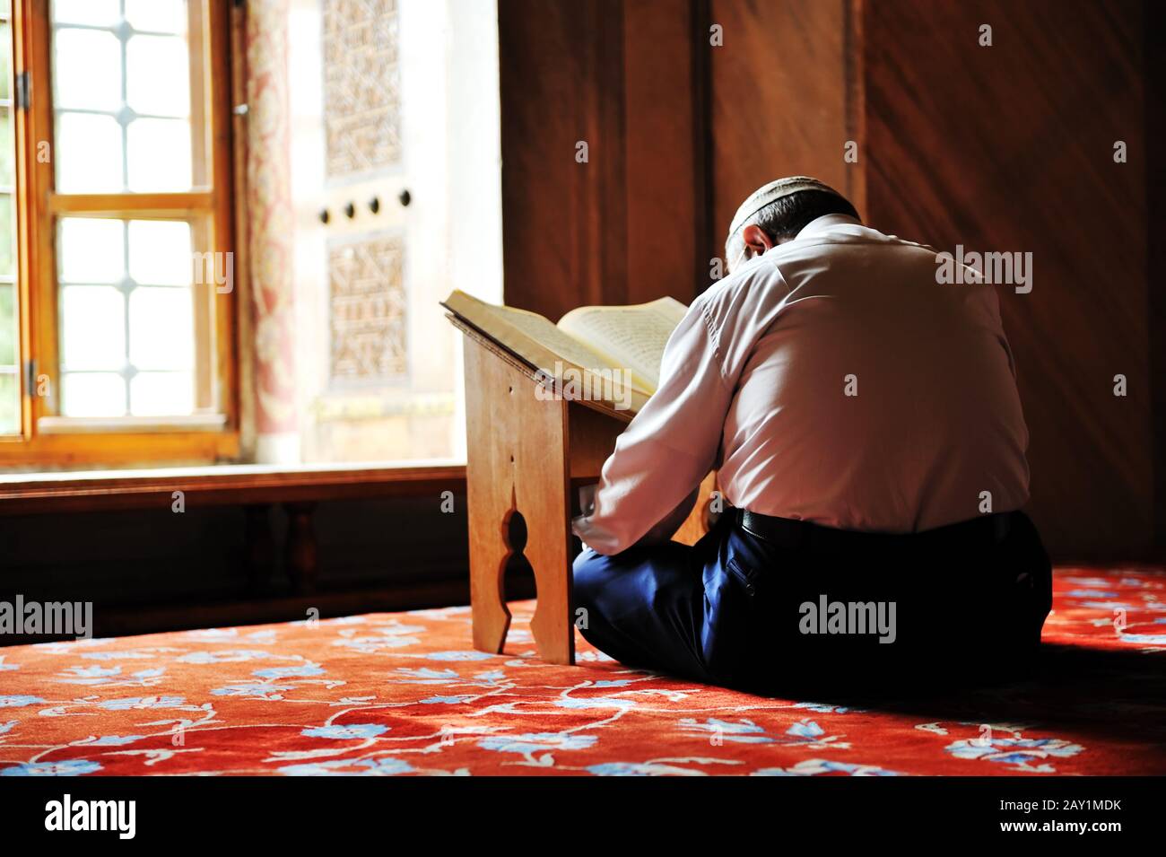 Prayer in mosque, reading Koran Stock Photo - Alamy