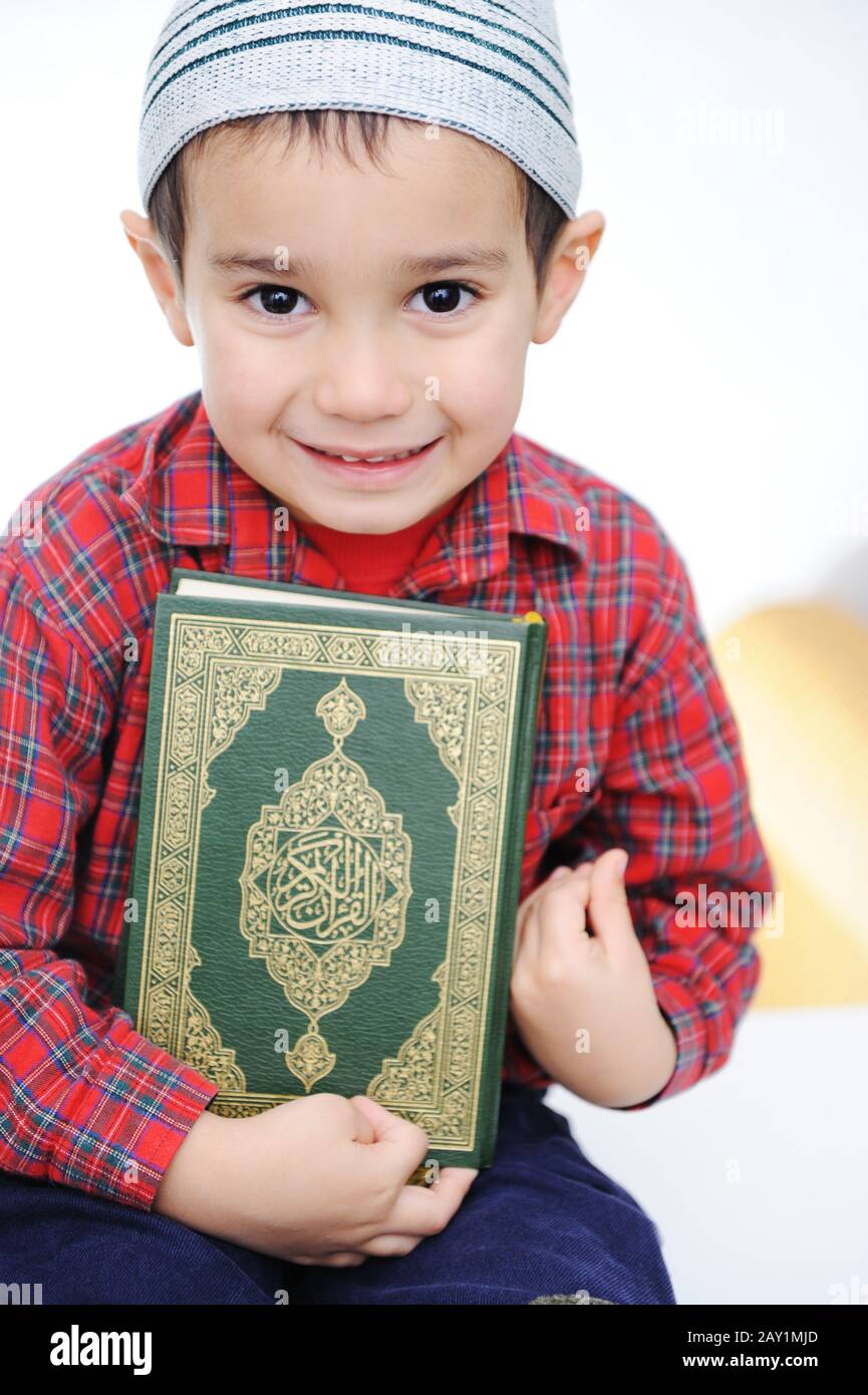 Muslim kid with holy book Koran Stock Photo - Alamy