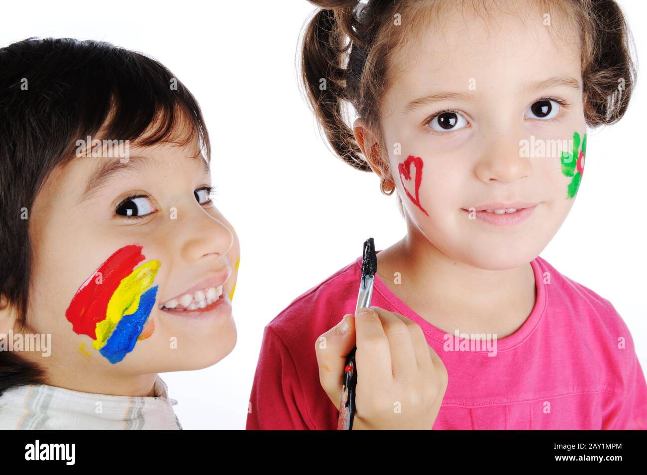 Two children painting on faces of each other Stock Photo - Alamy