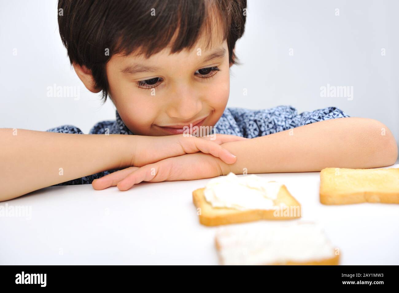 Kid eating bread Stock Photo - Alamy