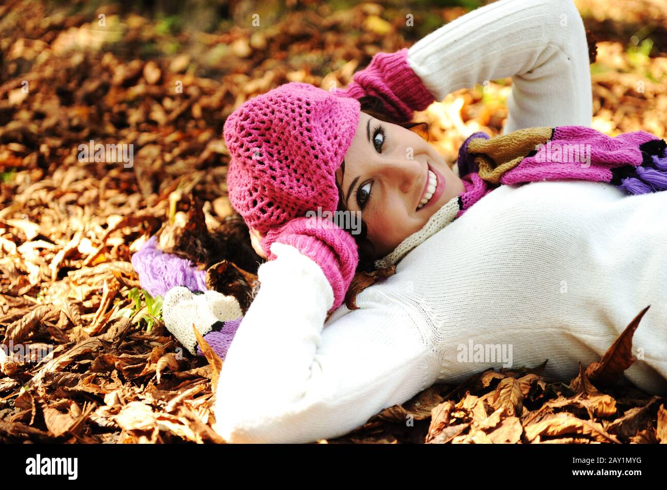 Young beauty girl laying on autumn ground and leaves, perfect face and ...