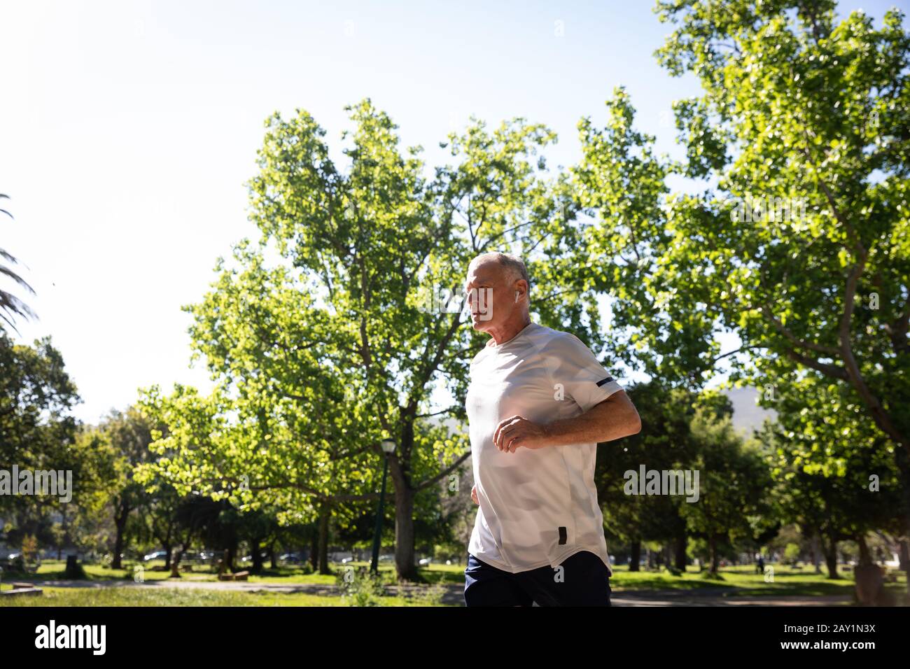 Sporty man running in park hi-res stock photography and images - Alamy