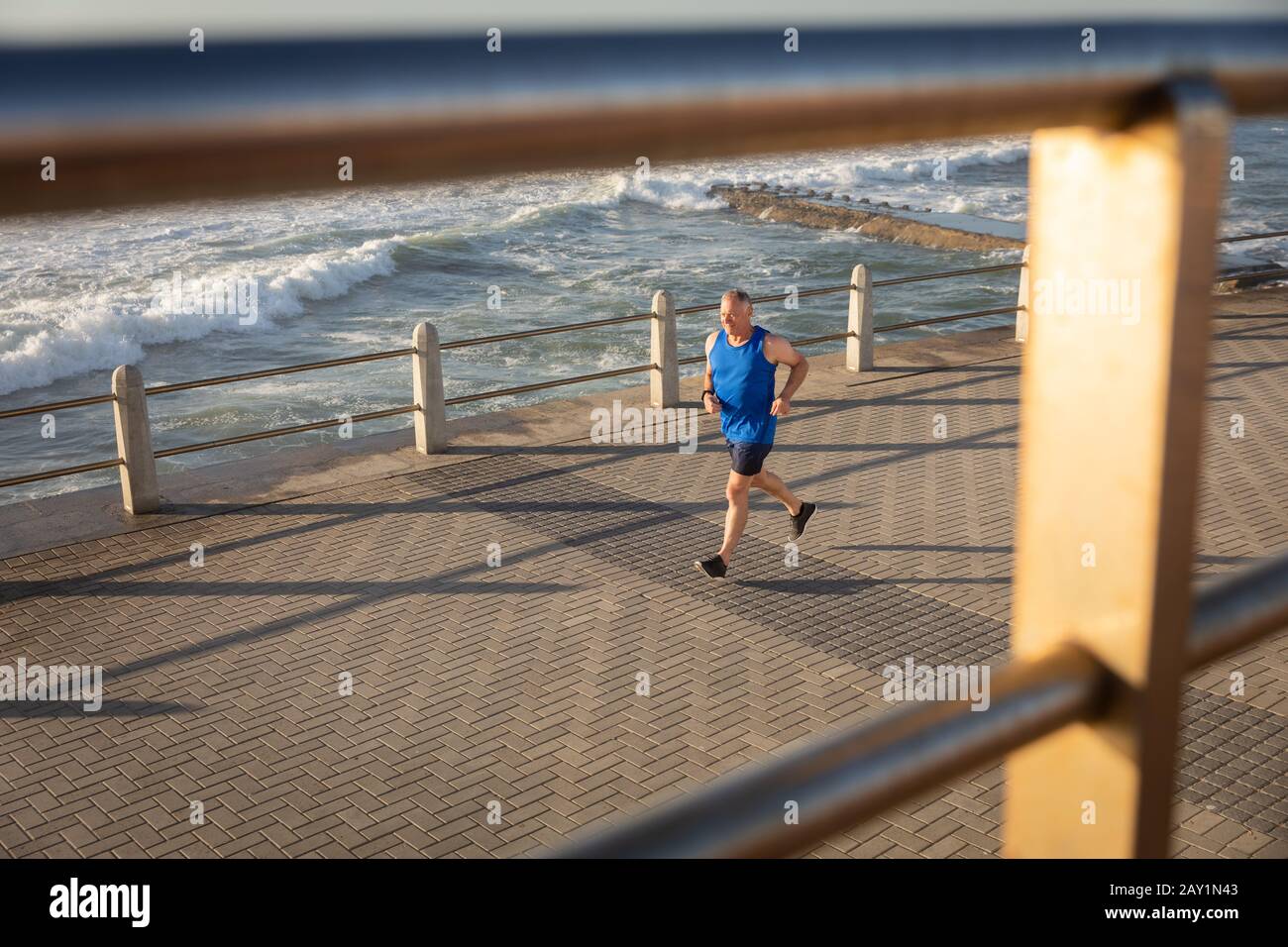 Jogger running on seaside Stock Photo - Alamy