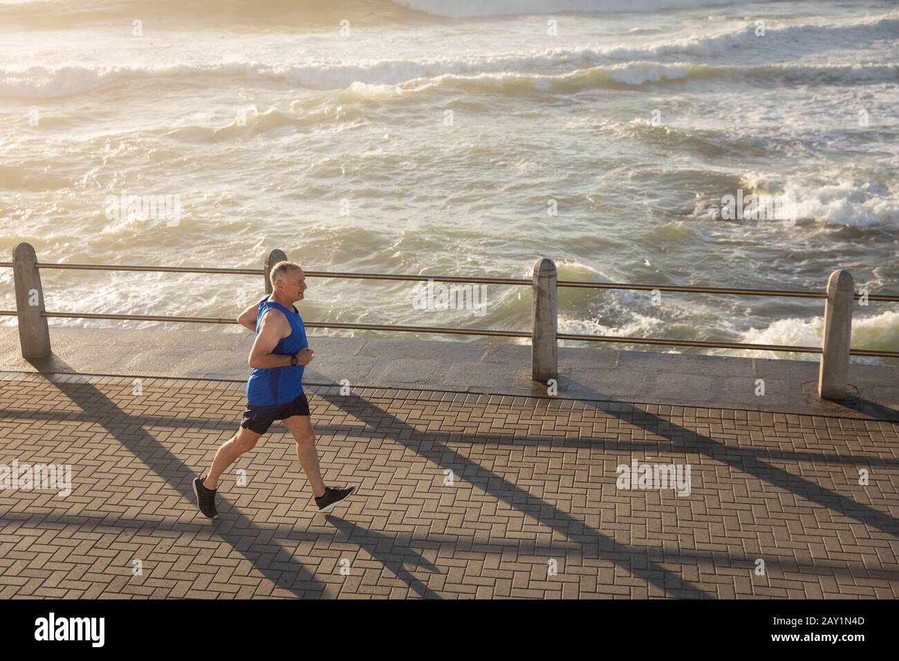 Jogger running on seaside Stock Photo - Alamy