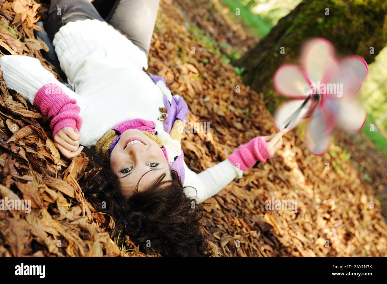 Young beauty girl laying on autumn ground and leaves, perfect face and ...