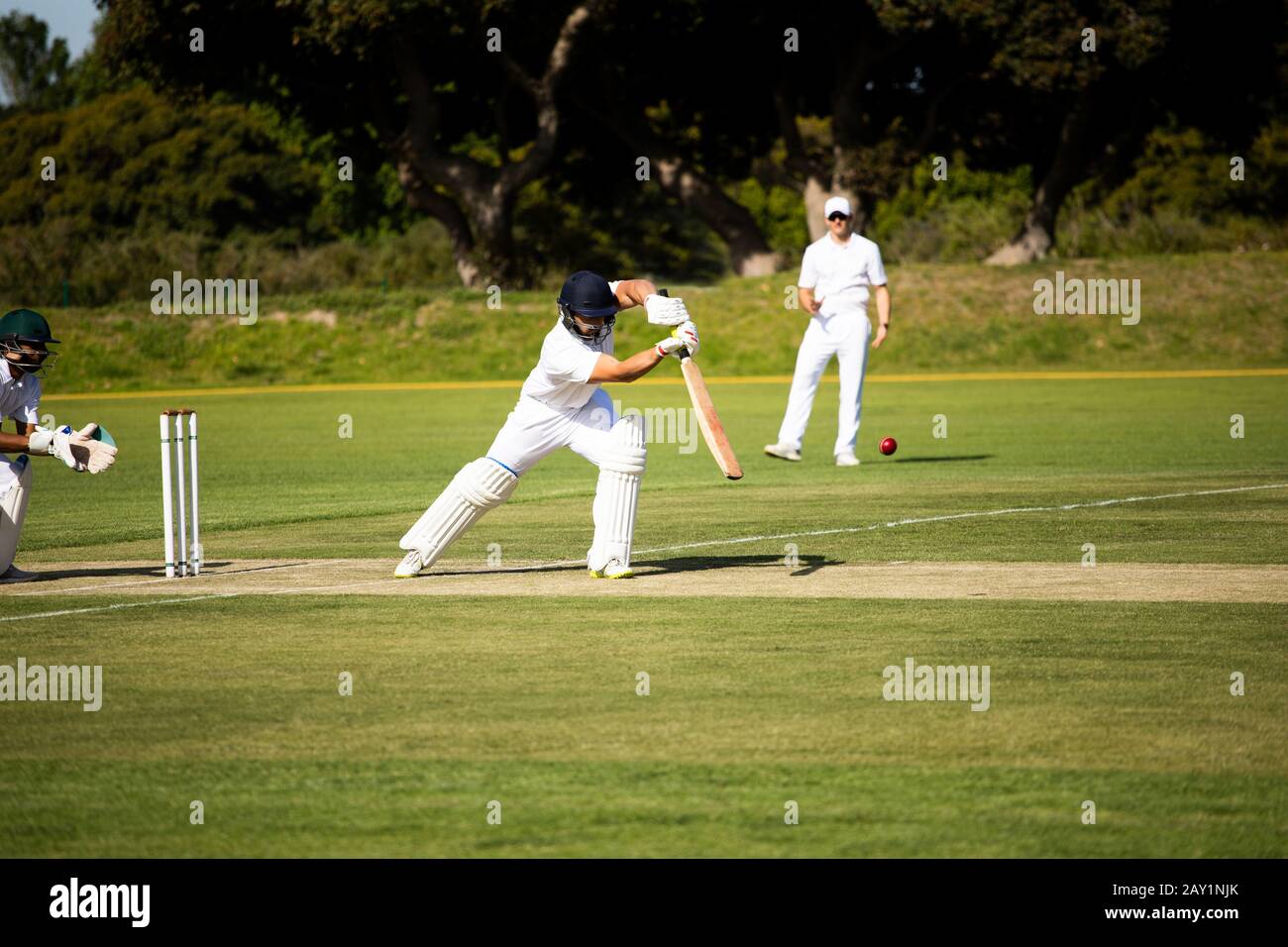 Cricket player shooting in the ball Stock Photo - Alamy