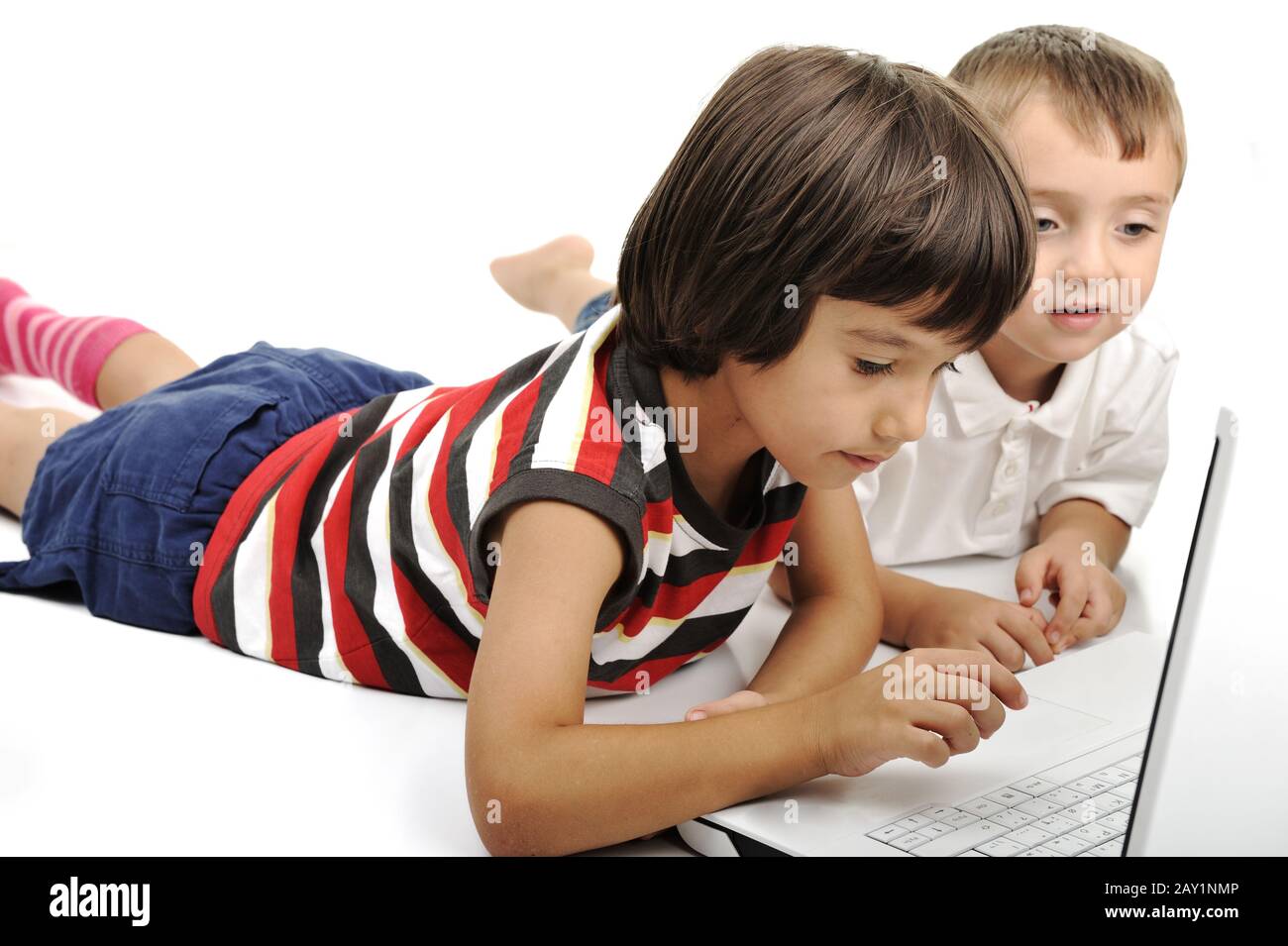Group of children playing on white laptop together. Isolated on white ...