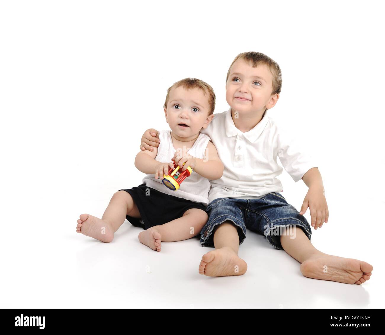 Two little brothers sitting, isolated Stock Photo - Alamy