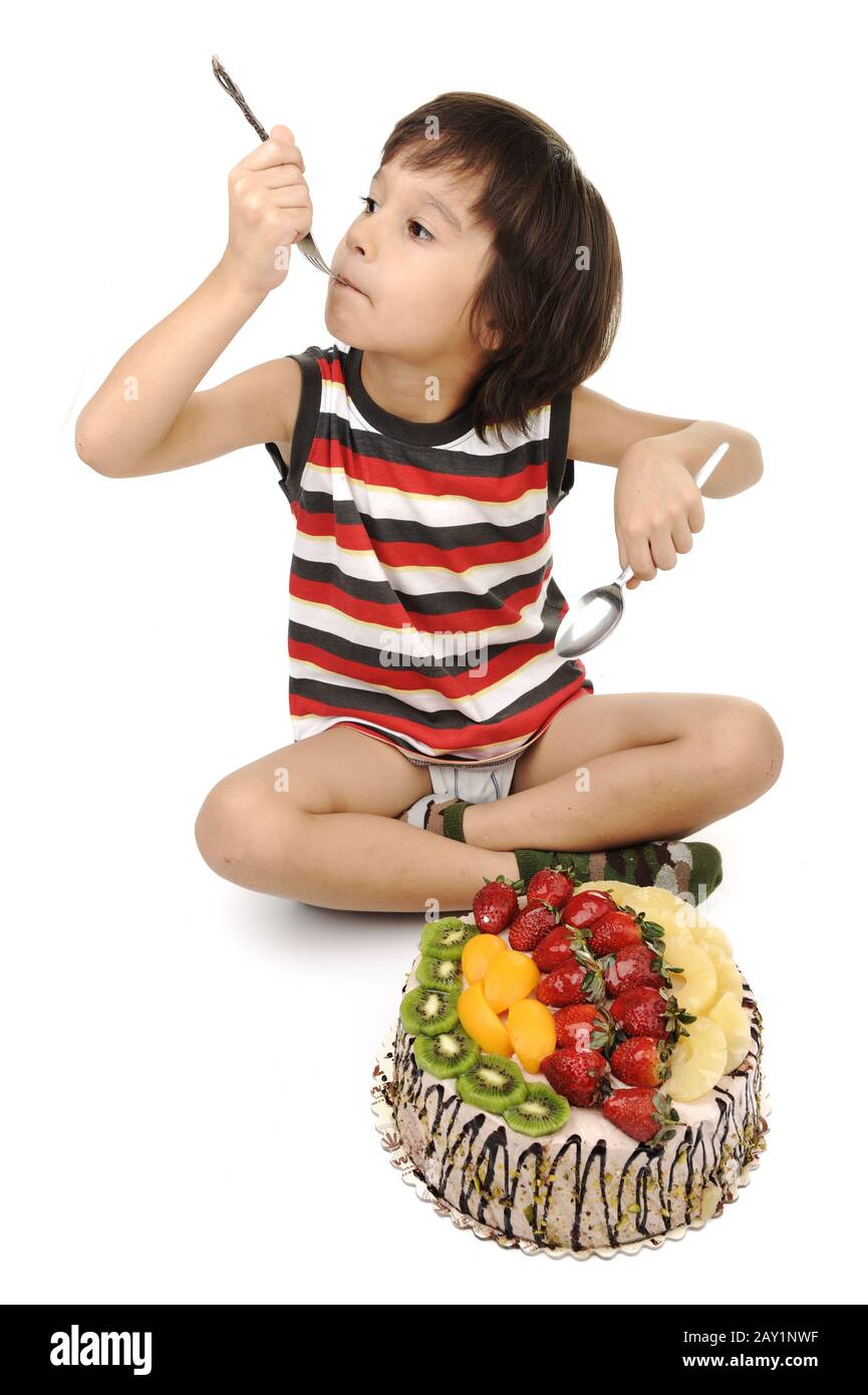 Happy kids eating birthday cake Cut Out Stock Images & Pictures - Alamy