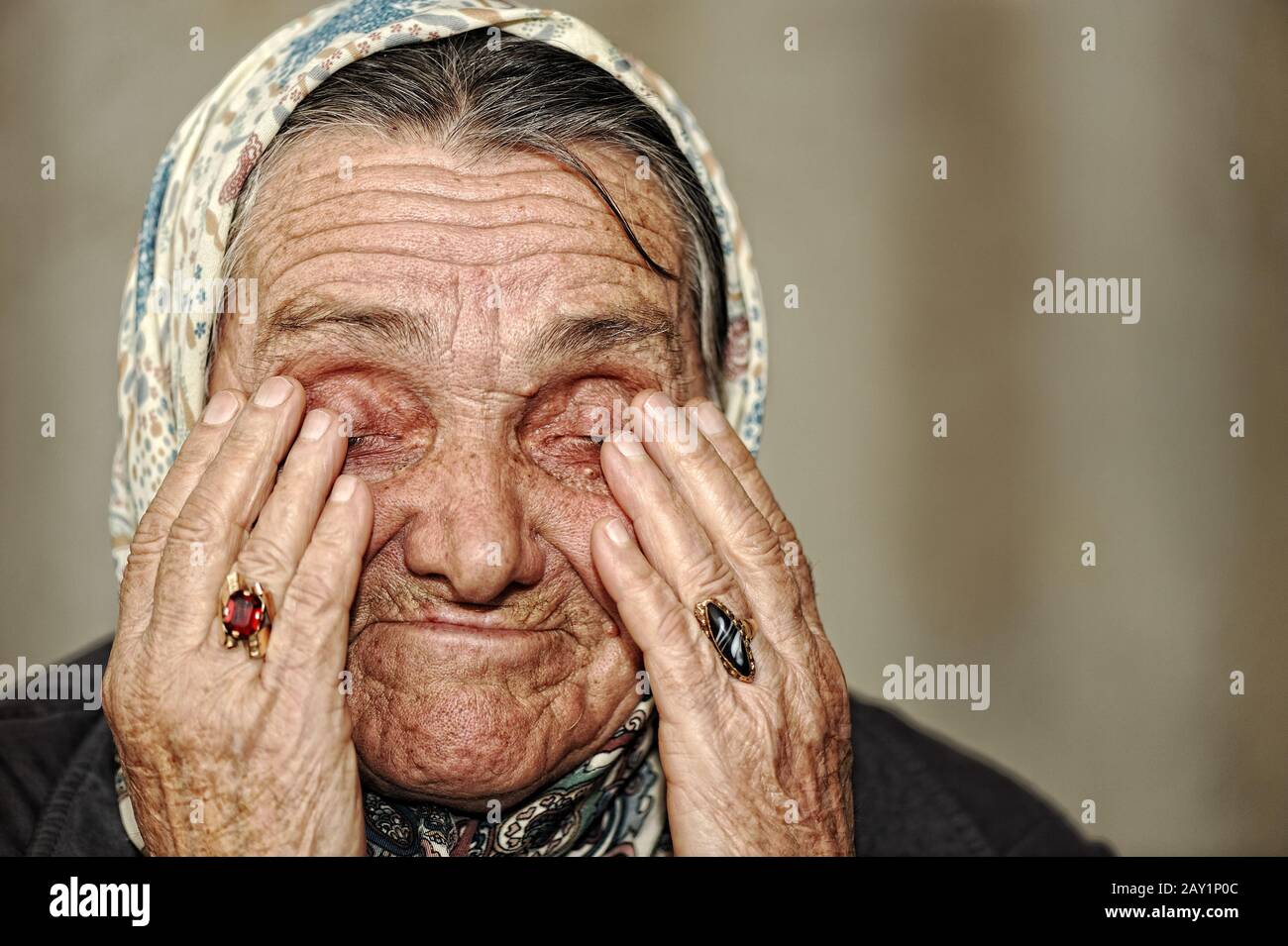 Mature woman crying with hands on her face Stock Photo - Alamy