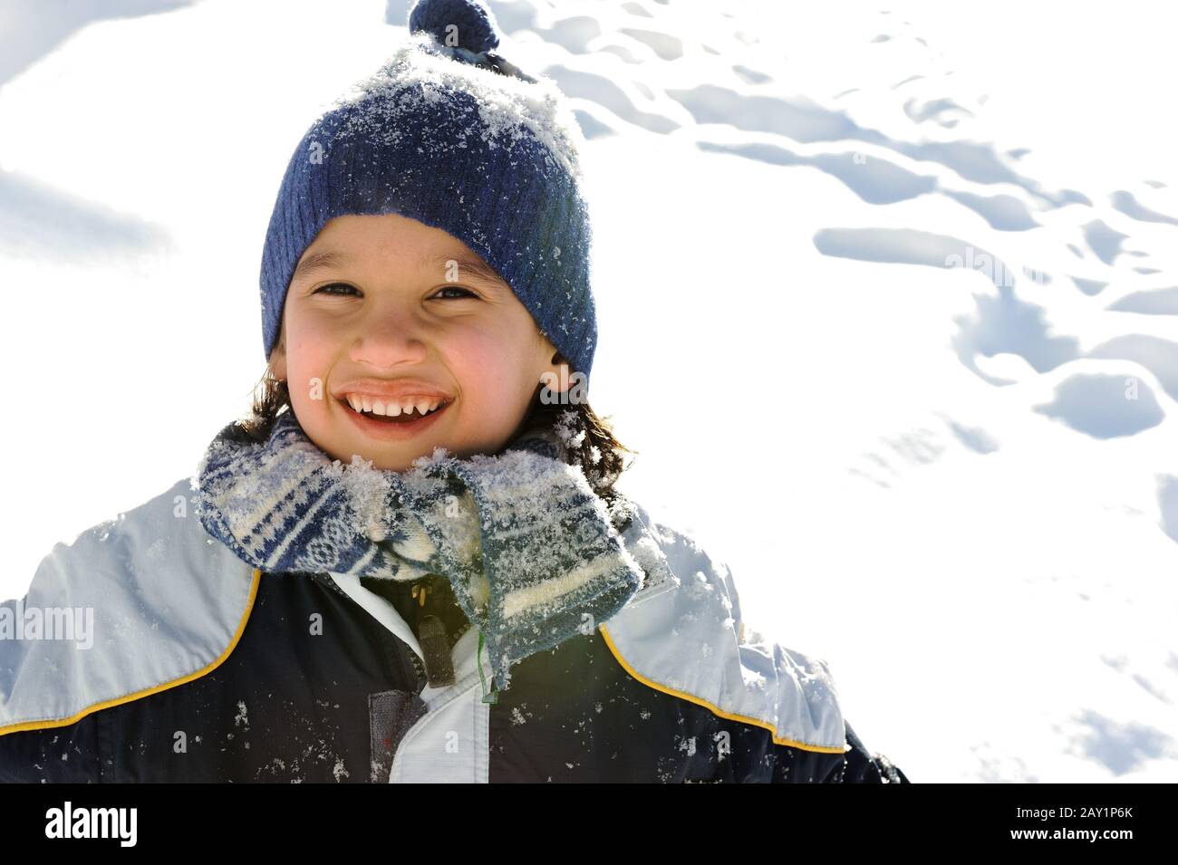 Happy boy on snow Stock Photo - Alamy