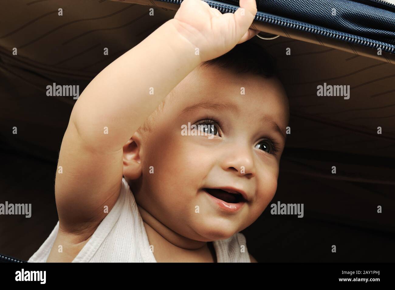 Baby child hiding and playing Stock Photo - Alamy