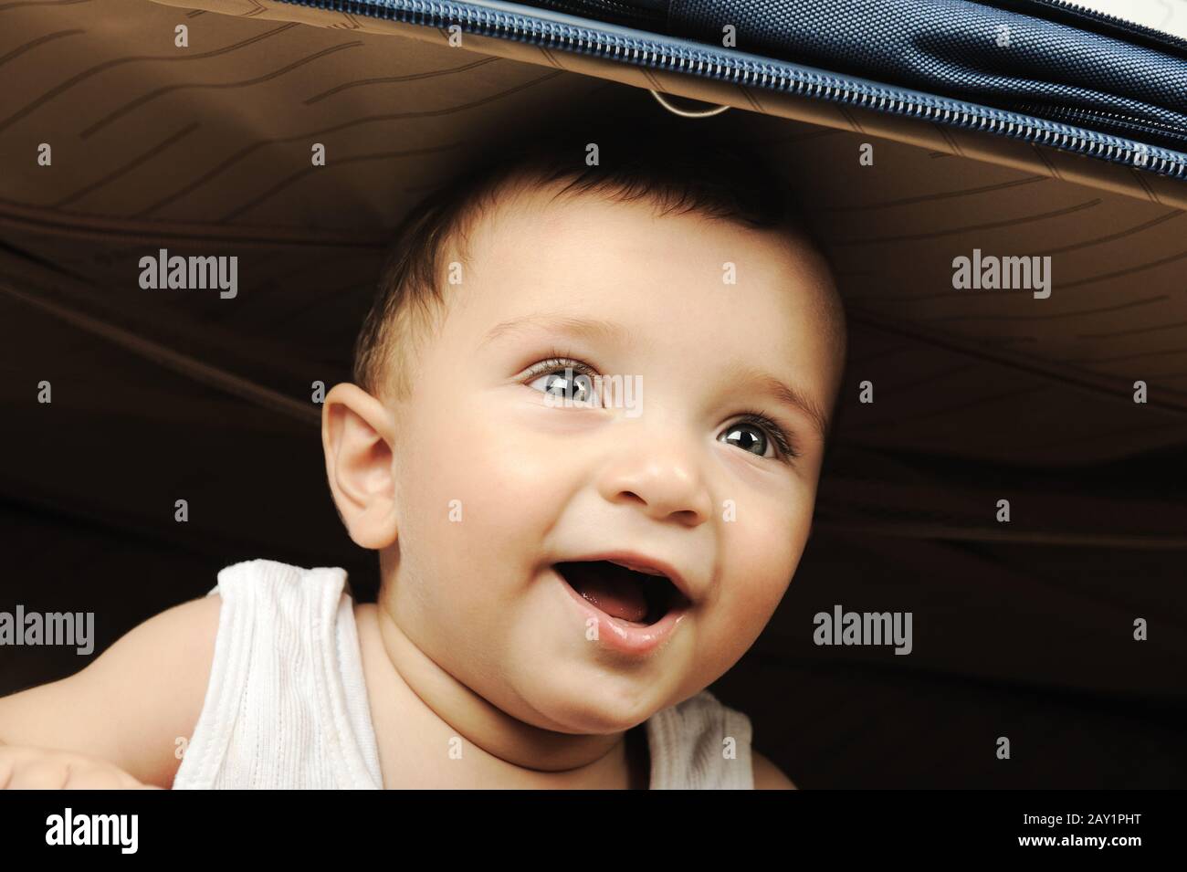 Baby child hiding and playing Stock Photo - Alamy