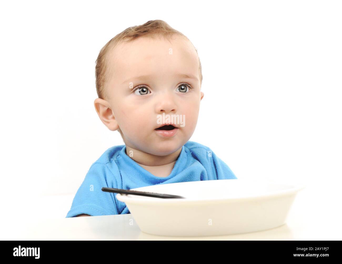 Cute adorable one year old baby with green eyes eating on table Stock ...