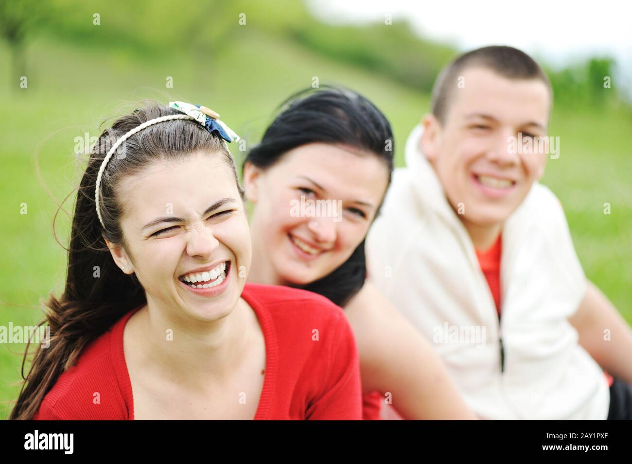 Happy laughing three teenagers outdoor Stock Photo - Alamy