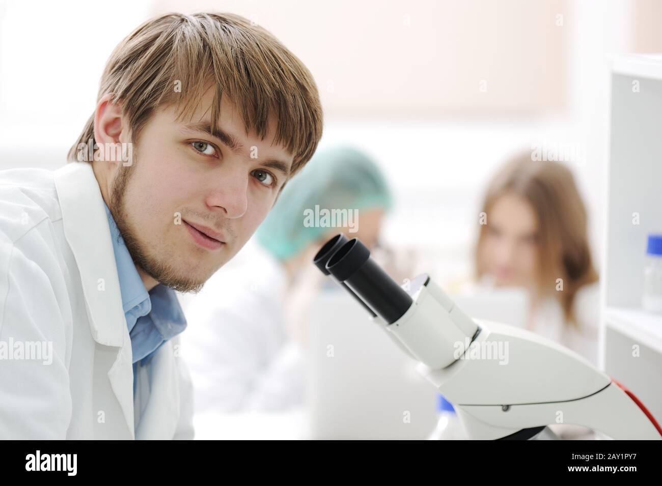 Team working with microscopes in a laboratory Stock Photo - Alamy