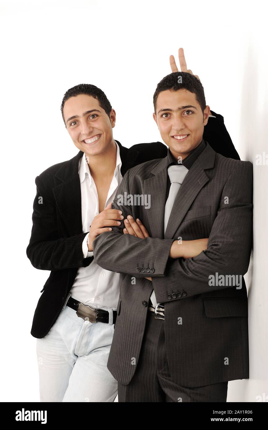 Two friends leaning against the wall isolated Stock Photo - Alamy