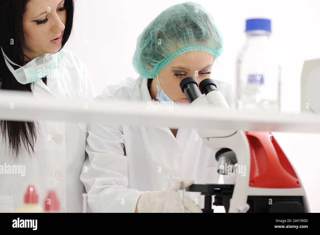 Two female scientists working at the laboratory with microscope Stock ...
