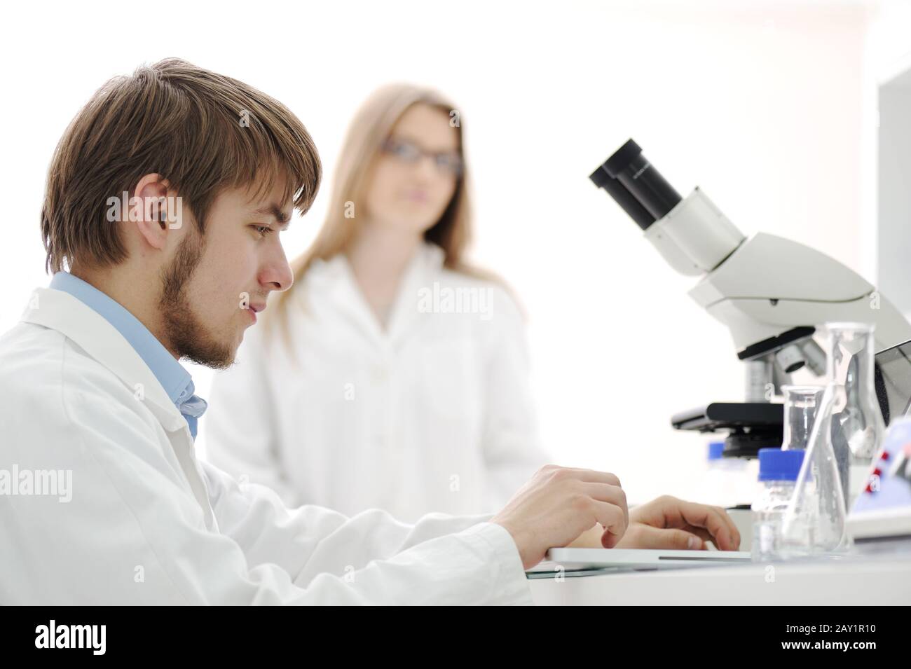 Science team working with microscopes in a laboratory Stock Photo - Alamy