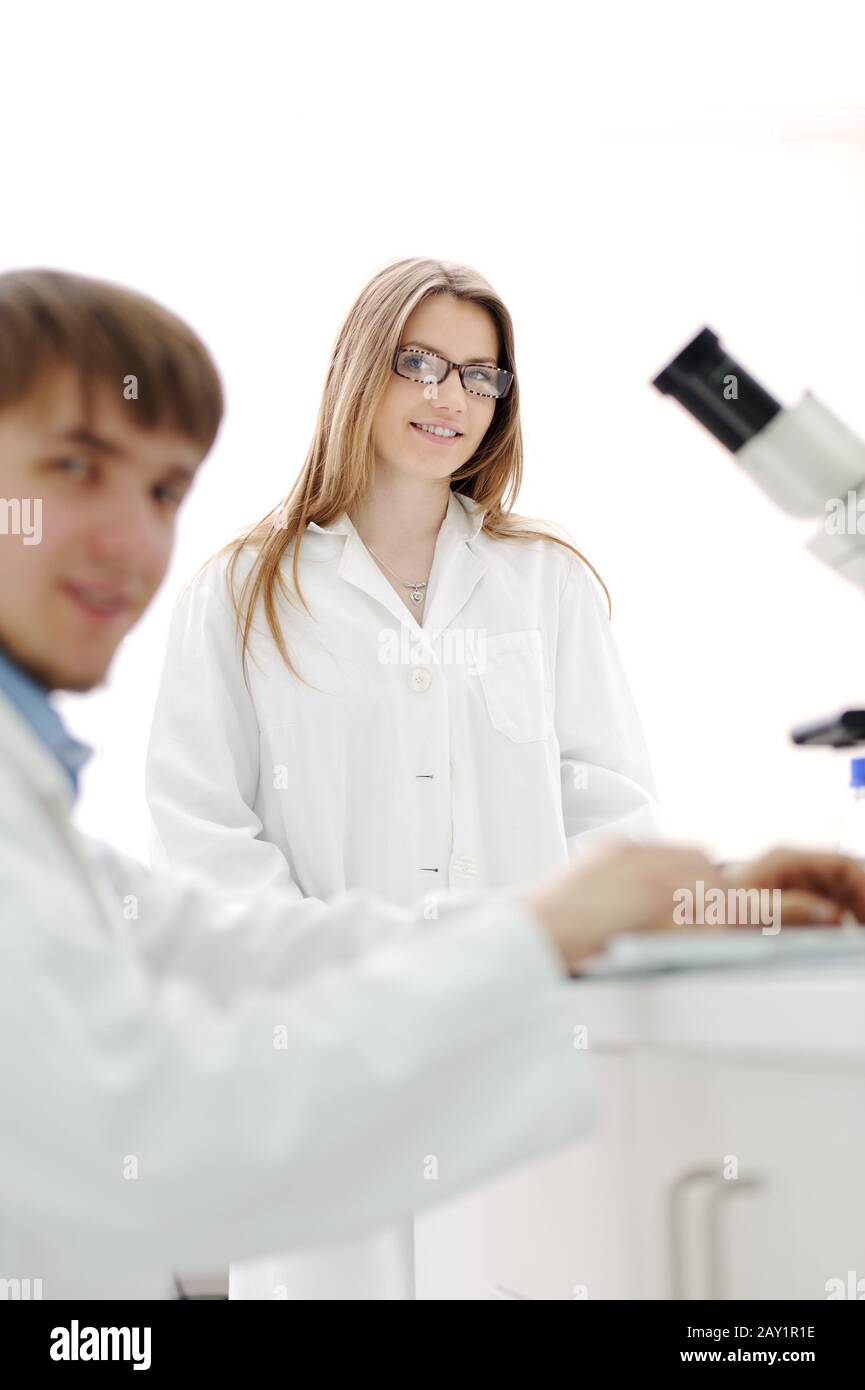 Science team working with microscopes in a laboratory Stock Photo - Alamy