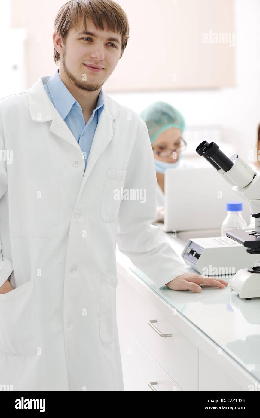 Successful team working with microscopes in a laboratory Stock Photo ...
