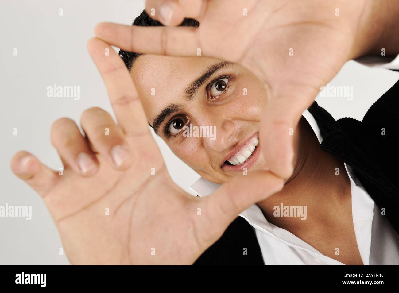 Young man making shape with his hands Stock Photo - Alamy