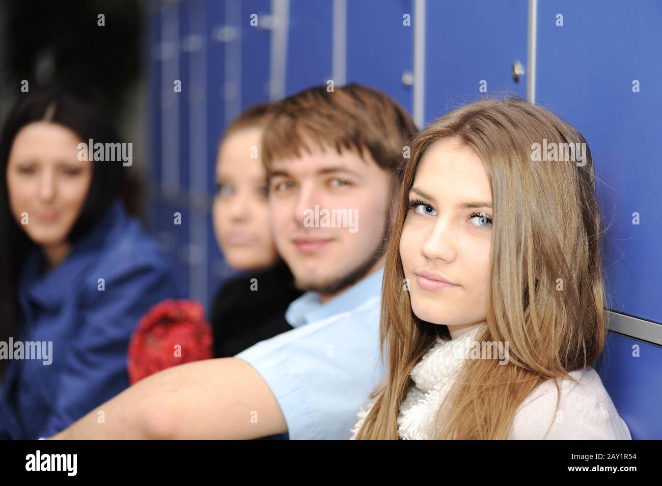 Group of four students outside sitting on floor inside Stock Photo - Alamy