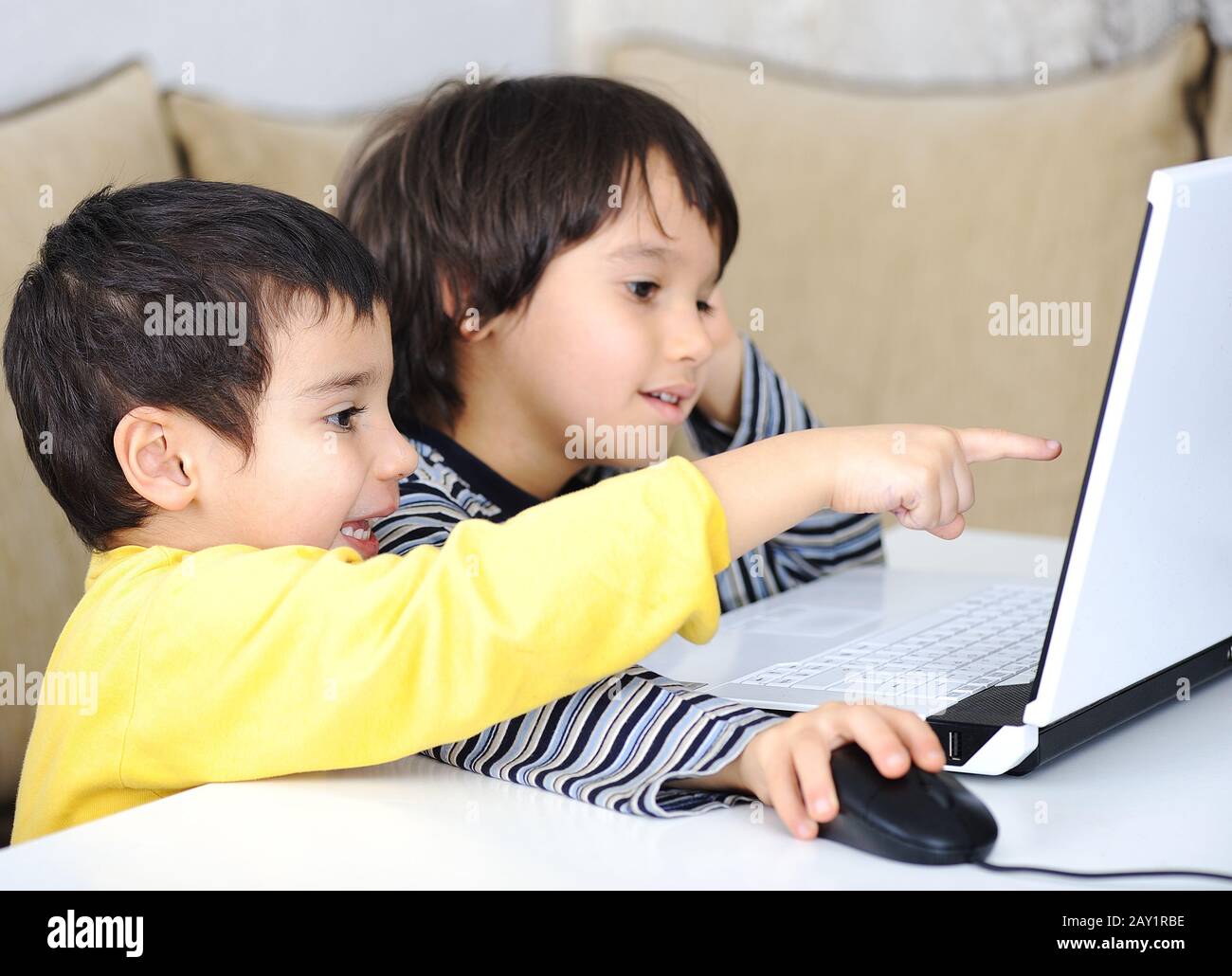 Childhood, laptop, learning and playing Stock Photo - Alamy