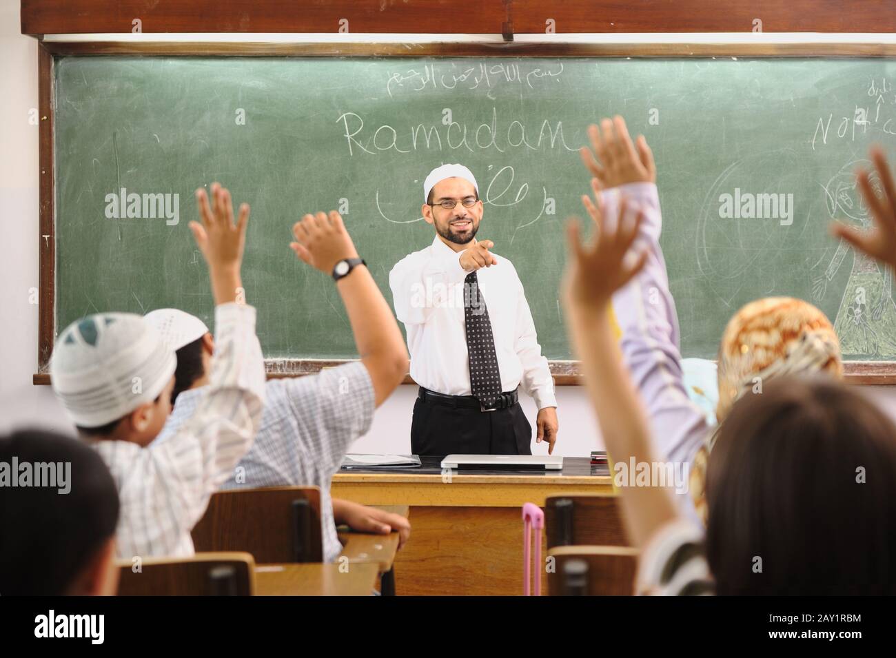 Muslim arabic children with teacher at school Stock Photo - Alamy