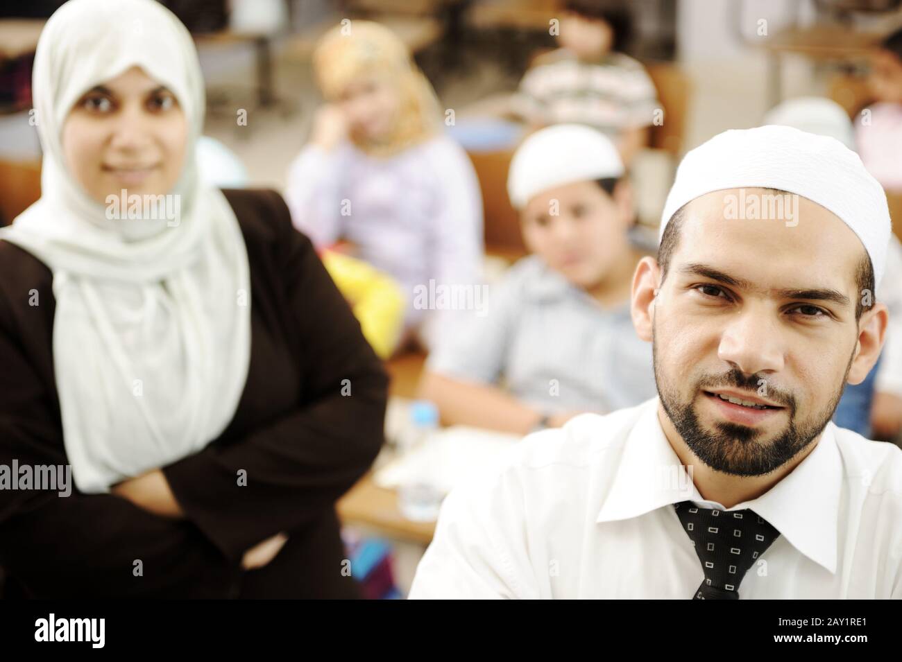 Muslim male and female teachers in classroom with childrens Stock Photo ...