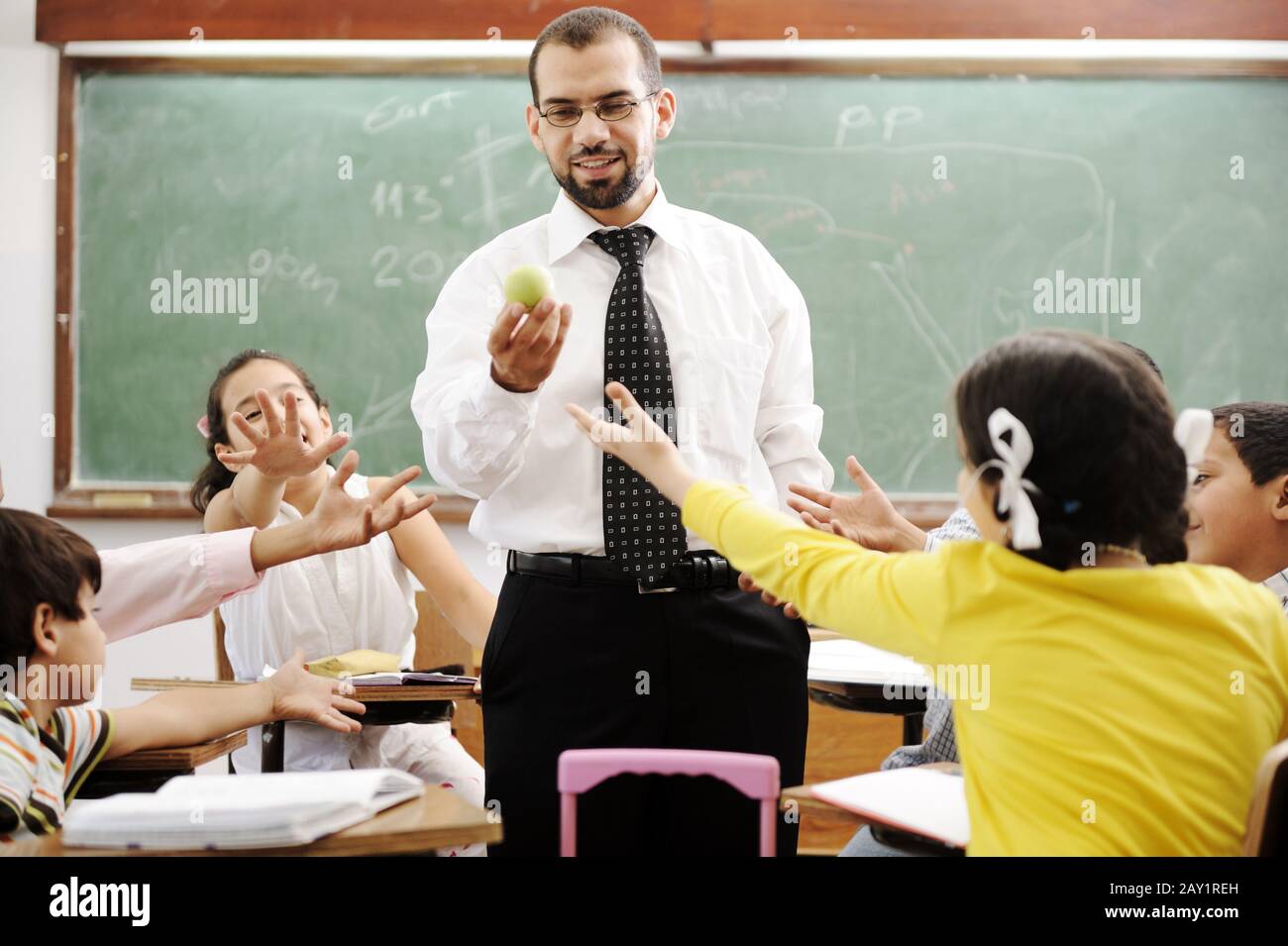 Young male teacher with children in modern school, activities Stock ...