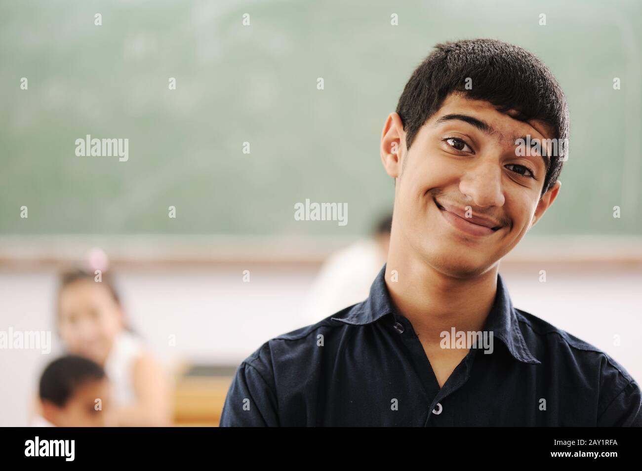 Happy student in classroom Stock Photo - Alamy