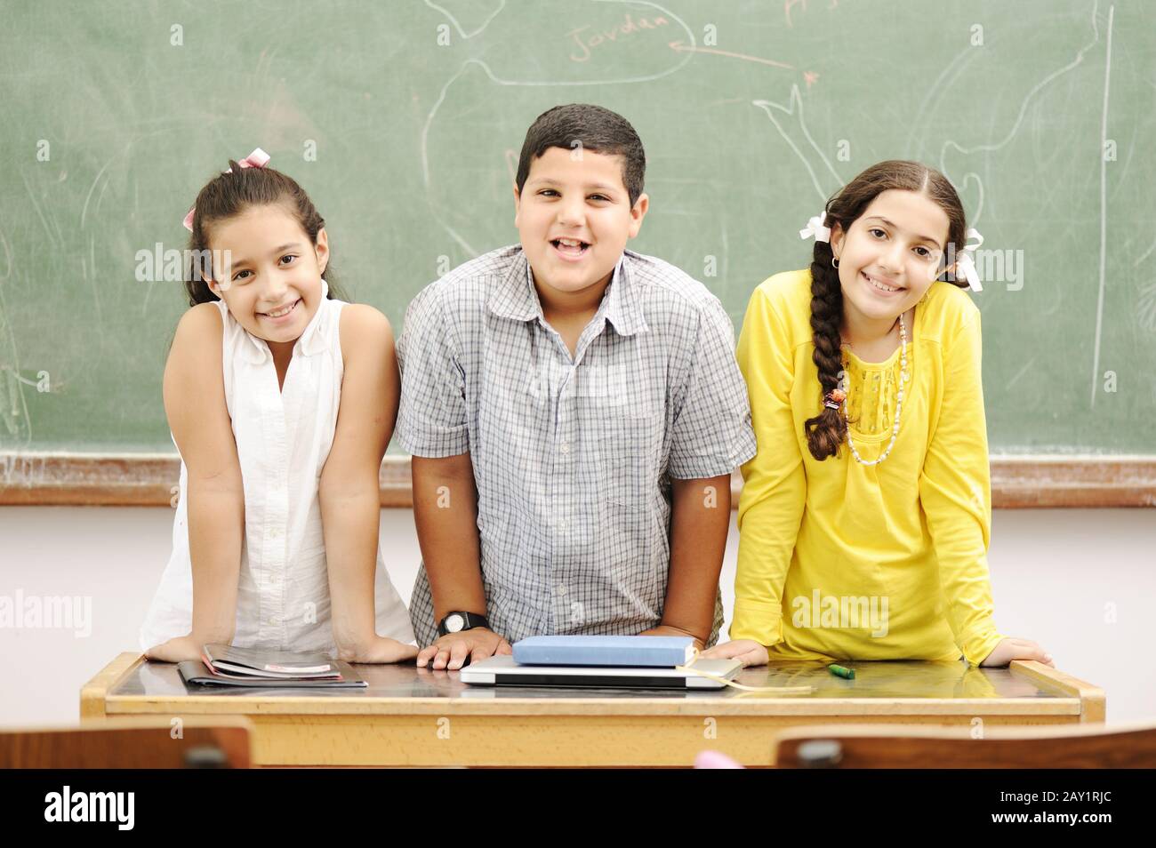 Happy children in classroom Stock Photo - Alamy