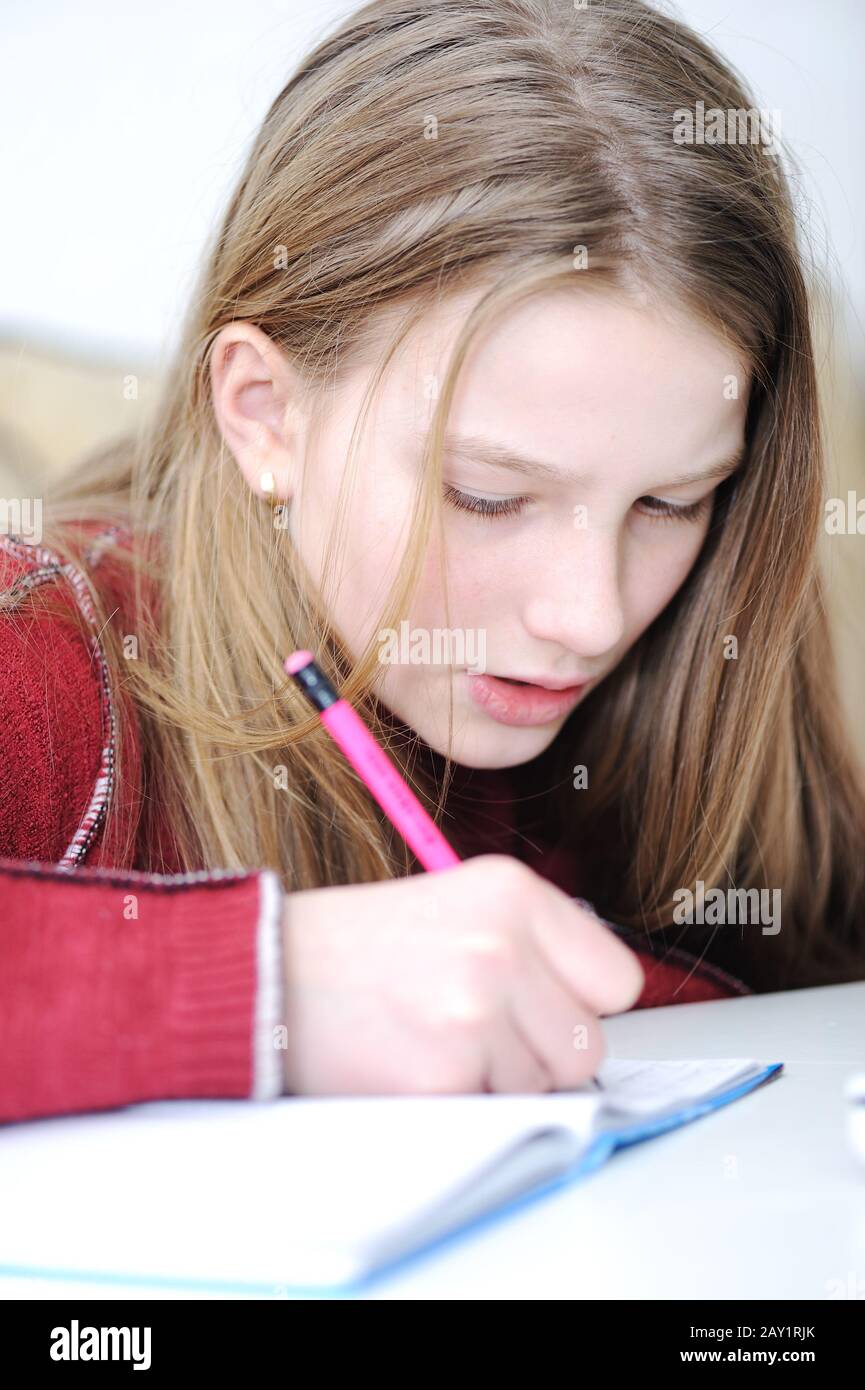 School girl writing hi-res stock photography and images - Alamy