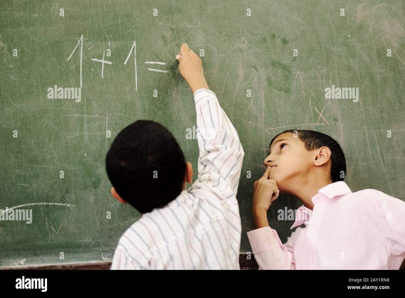 Asian boy writing on blackboard hi-res stock photography and images - Alamy