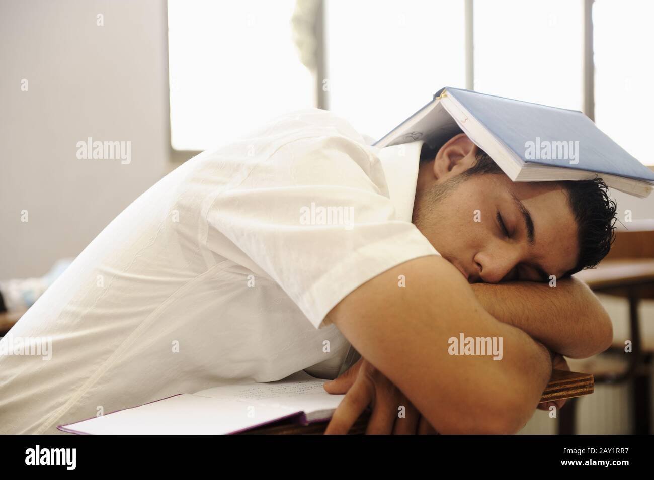 Teen student sleeping at classroom Stock Photo - Alamy