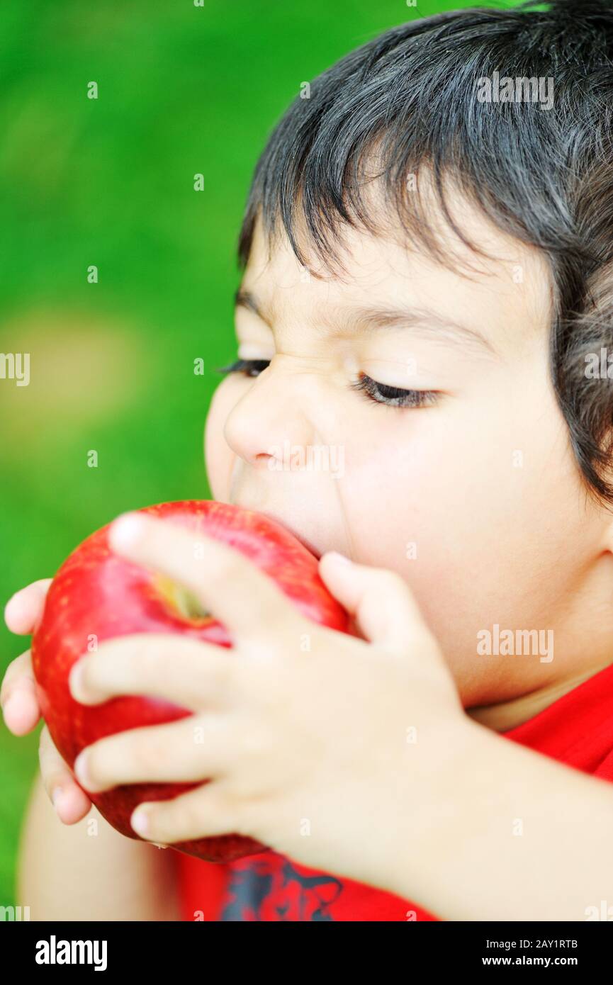 Beautiful boy eating apple hi-res stock photography and images - Alamy