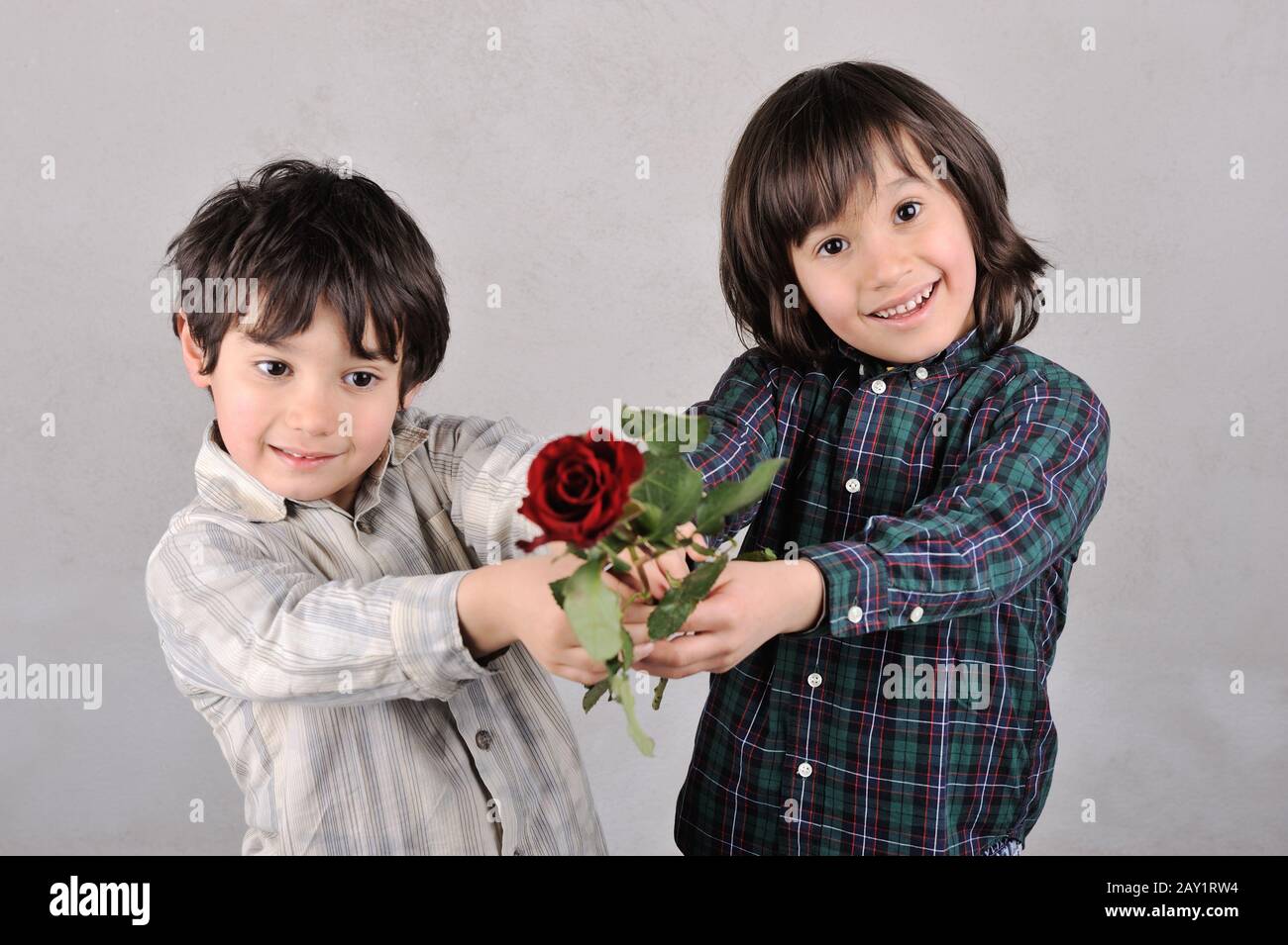 Two boys with red rose Stock Photo - Alamy