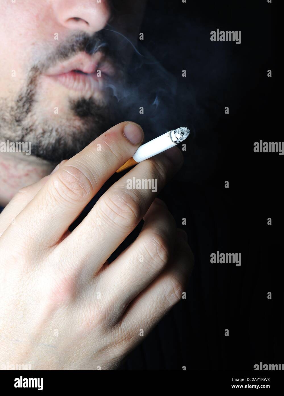 Man smoking in dark with visible smoke Stock Photo - Alamy