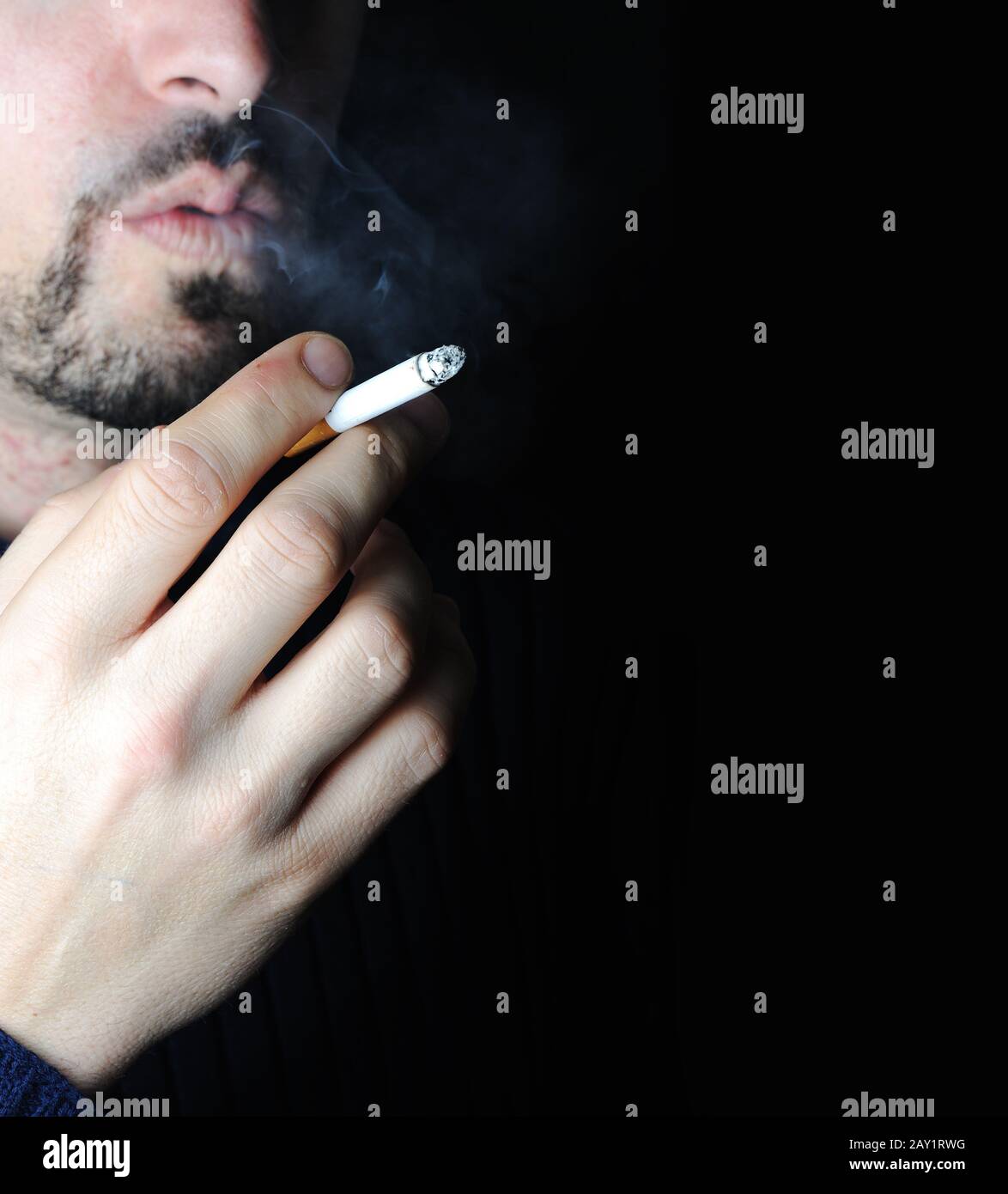 Man smoking in dark with visible smoke Stock Photo - Alamy