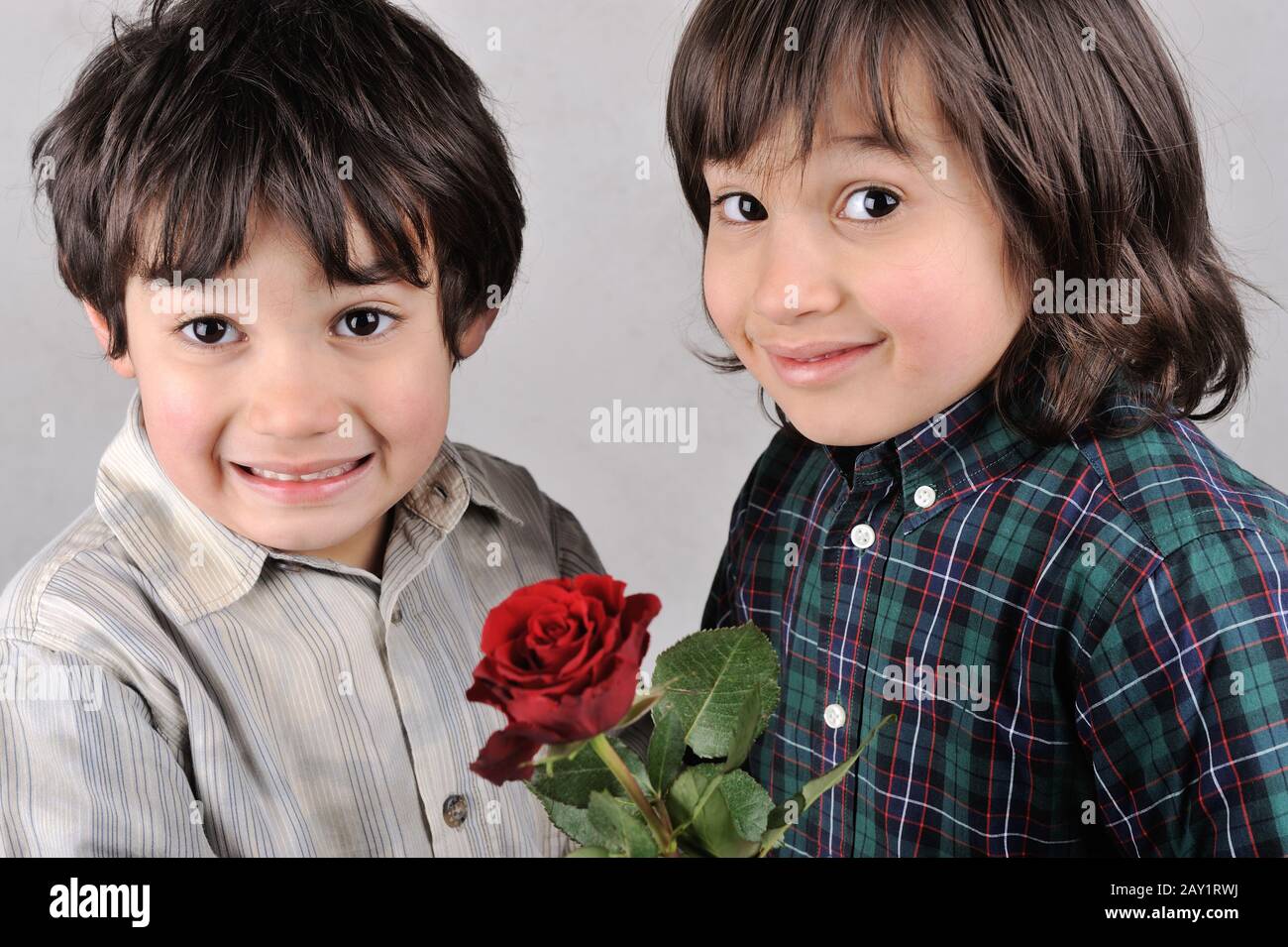 Two boys with beautiful red rose Stock Photo - Alamy